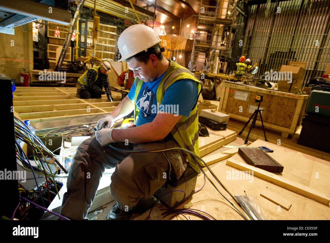 Electrician installing cabling, working on a building site Stock Photo ...