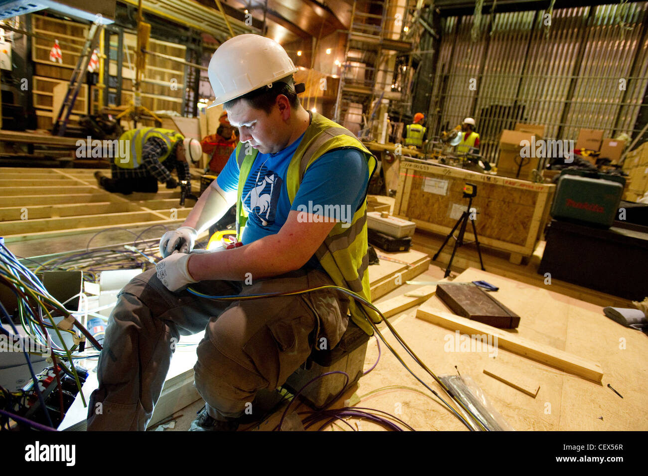 Electrician installing cabling, working on a building site Stock Photo ...