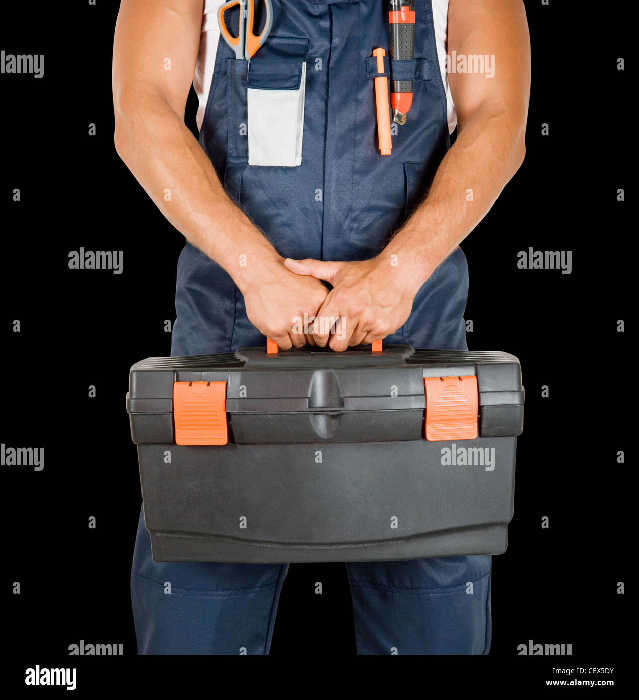 repairman with box of instruments on black background Stock Photo - Alamy