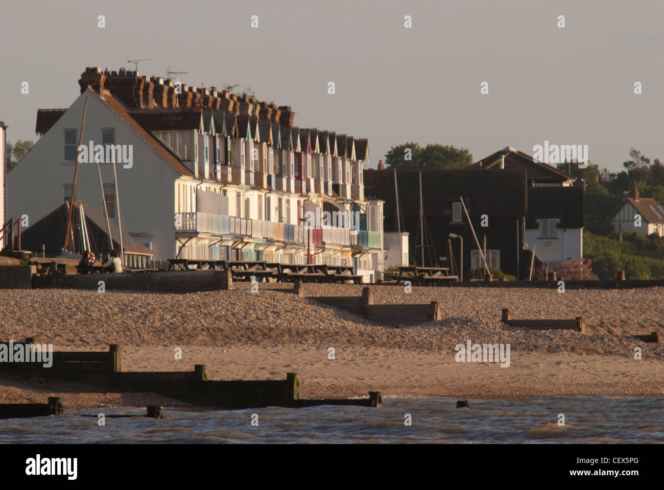 A view of a seaside terrace of houses on the beach at Whitstable Stock ...
