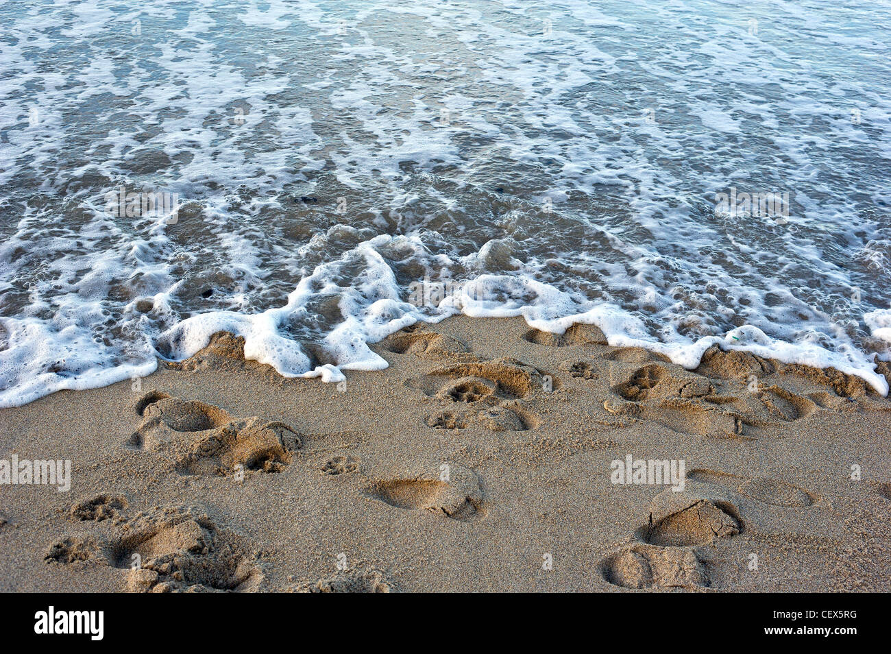 Incoming tide on a beach Stock Photo - Alamy