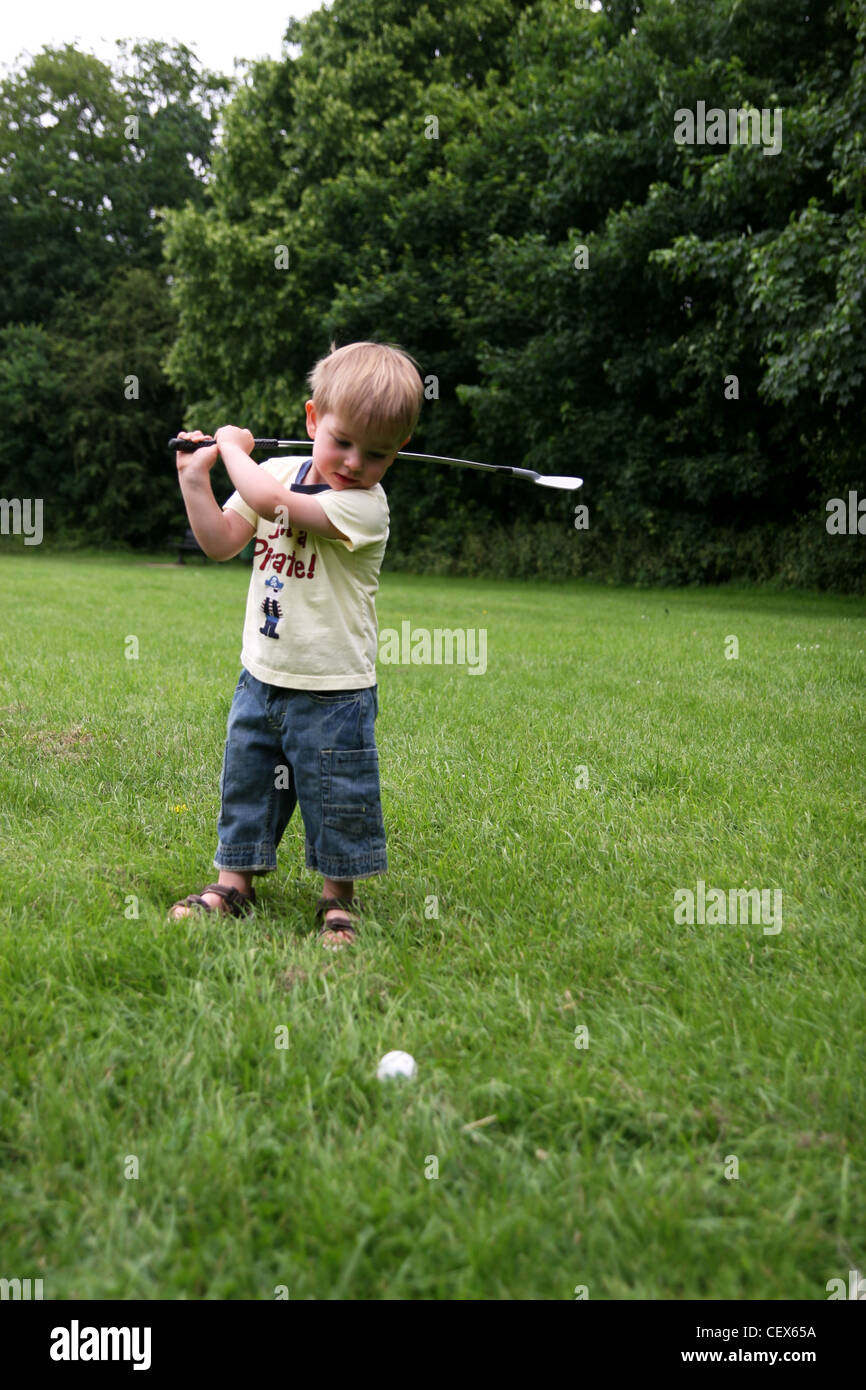 Male child playing golf in park Stock Photo - Alamy