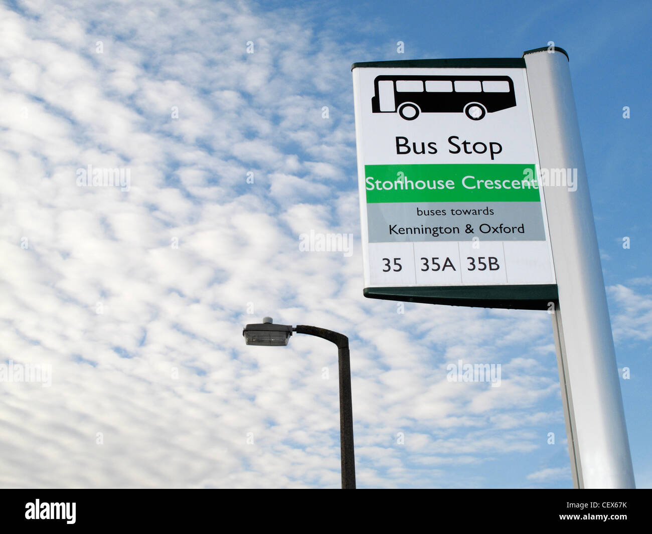 A bus stop sign and lamp post in Radley Village, Oxfordshire Stock ...