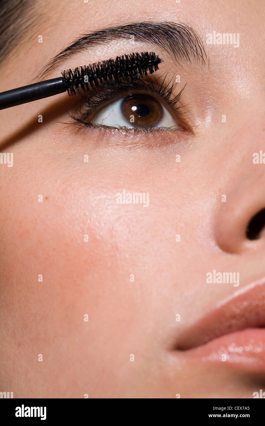 Female applying black mascara Stock Photo - Alamy