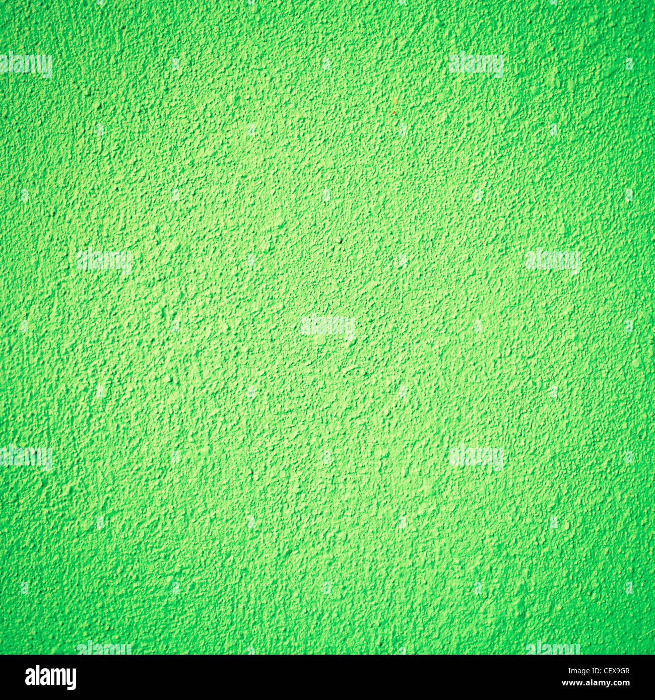 A vibrant green textured plaster background image Stock Photo - Alamy