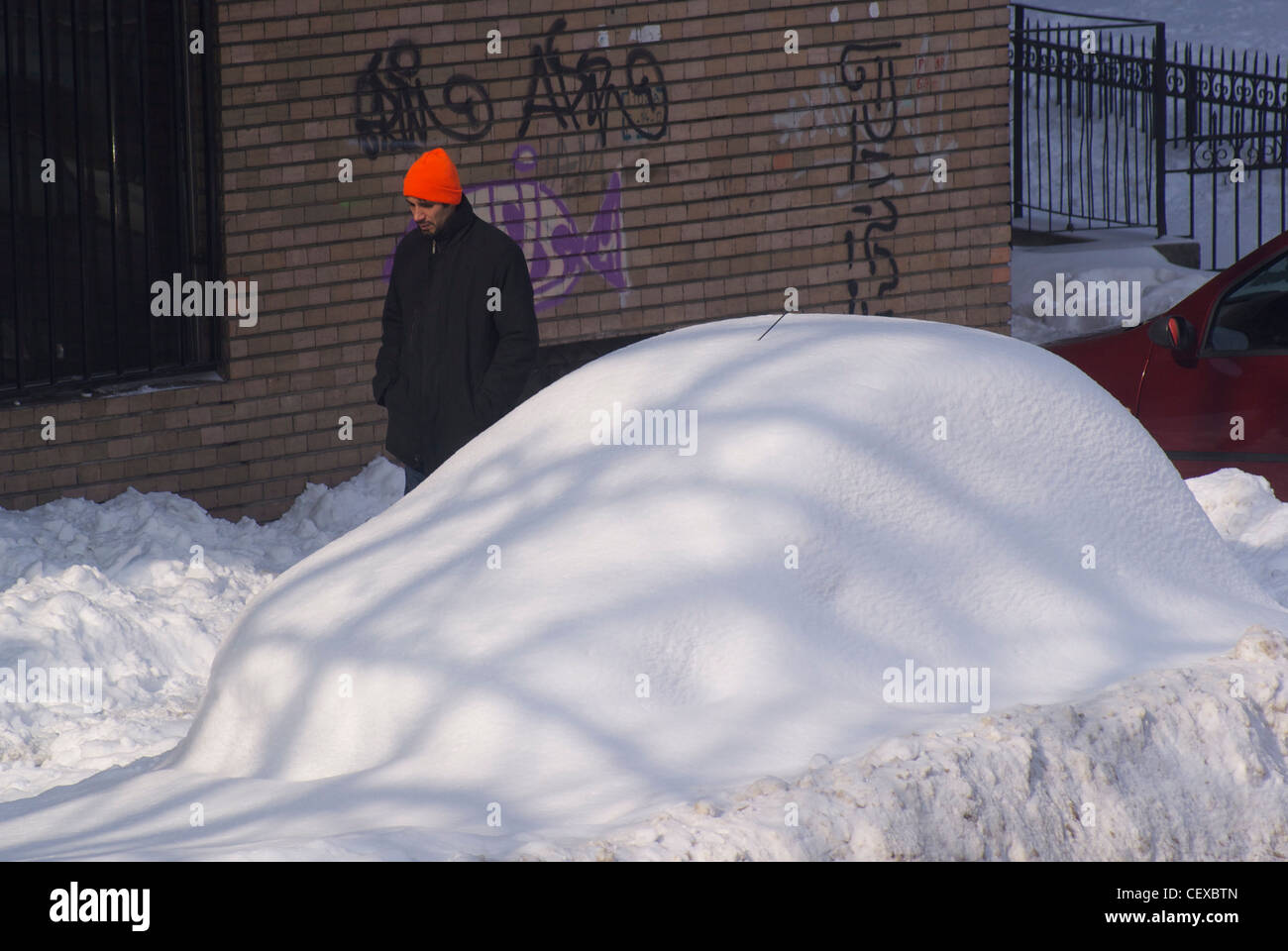 Man walking past a car completely covered in snow, Bucharest, Romania ...