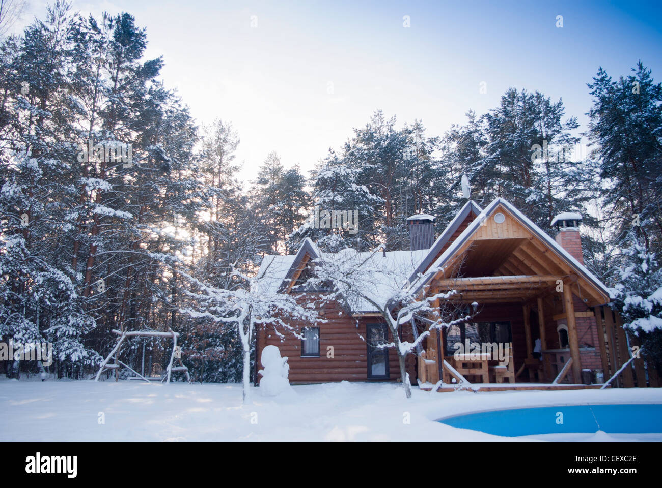 wooden house covered with snow in winter surrounded by forest Stock ...