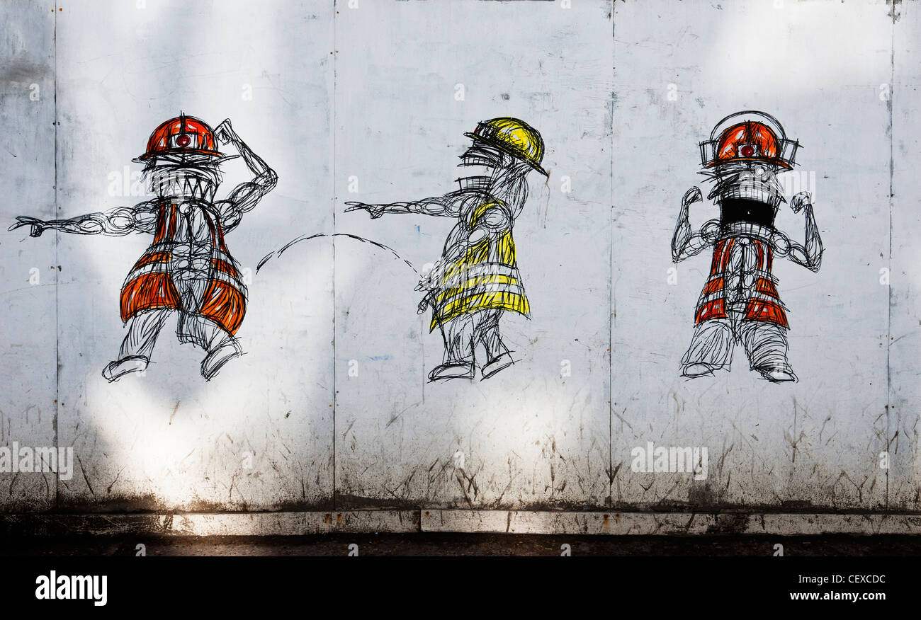 Amusing graffiti art of workmen on the side of a building site hoarding, London SE1 UK Stock ...