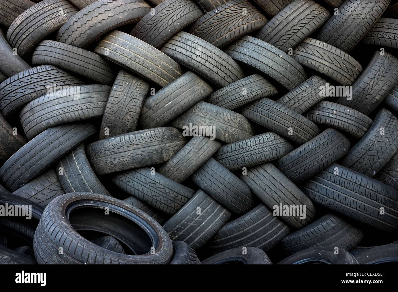 Car tyres stacked in a pattern in London Stock Photo - Alamy