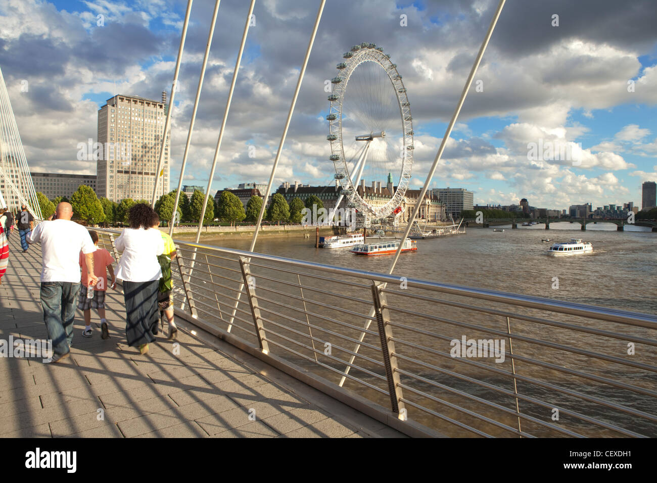 A view of the London Eye framed by the suspension cables on the ...