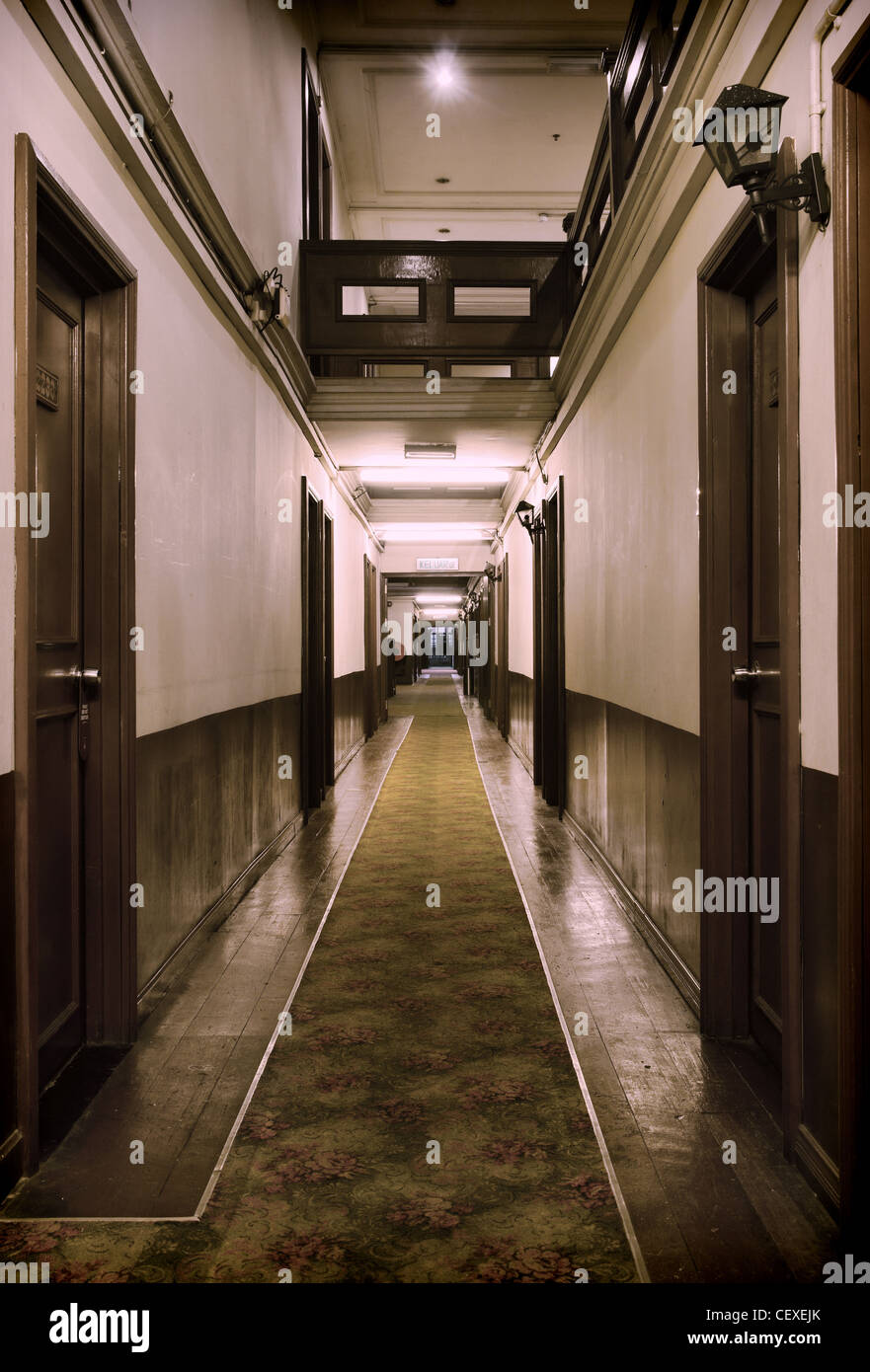 hallway with rooms inside a rough old hotel Stock Photo - Alamy