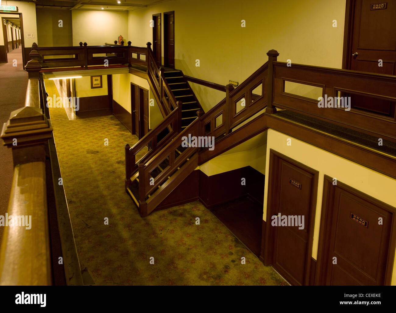hallway with rooms inside a rough old hotel Stock Photo - Alamy