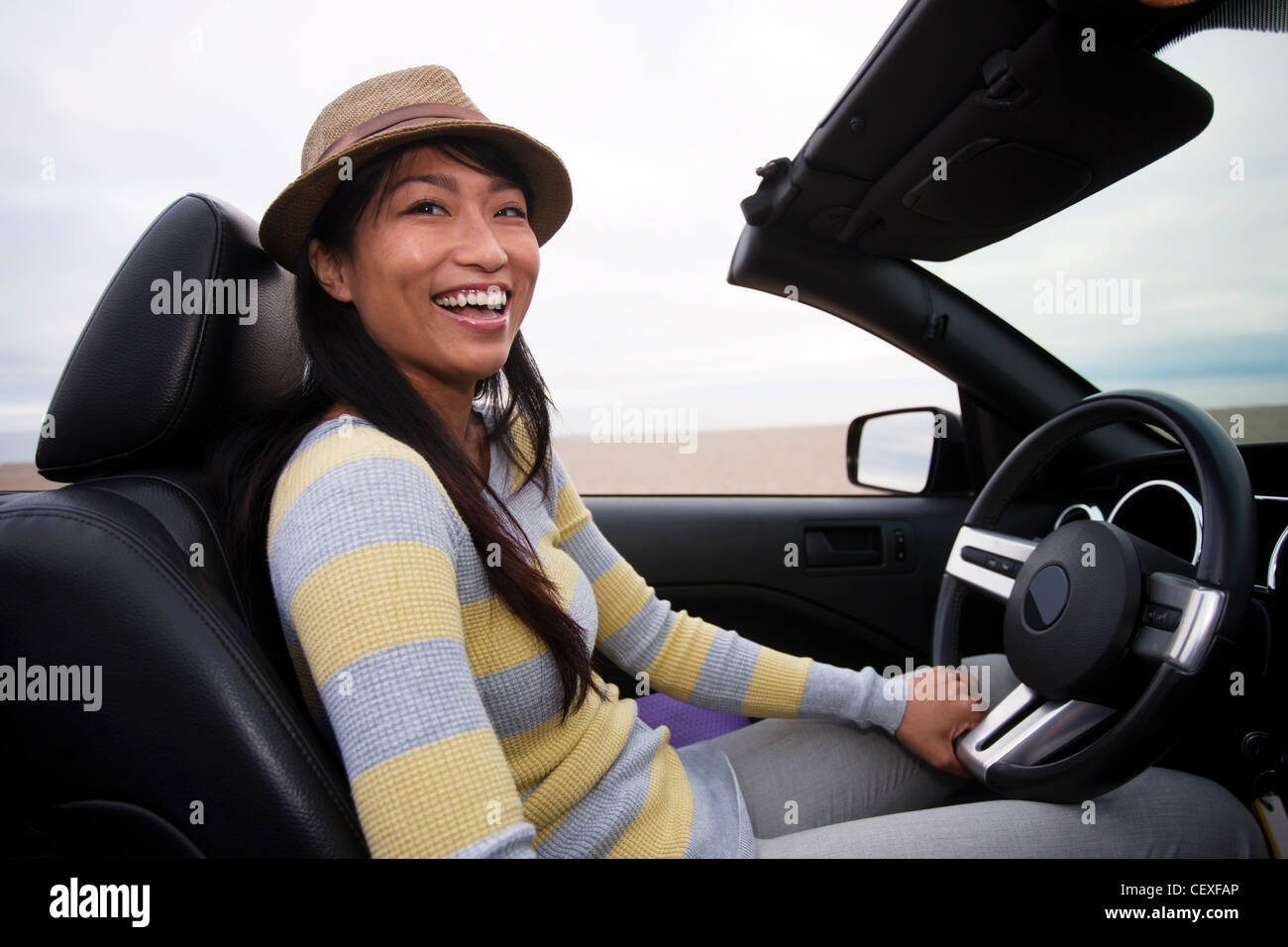 Chinese woman driving convertible Stock Photo - Alamy