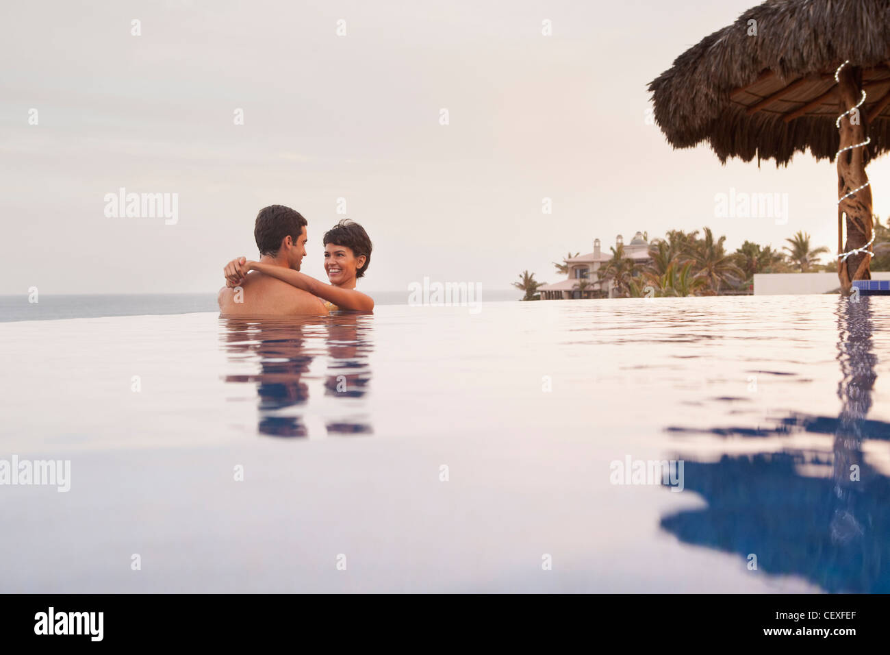 Hispanic couple hugging in swimming pool Stock Photo - Alamy
