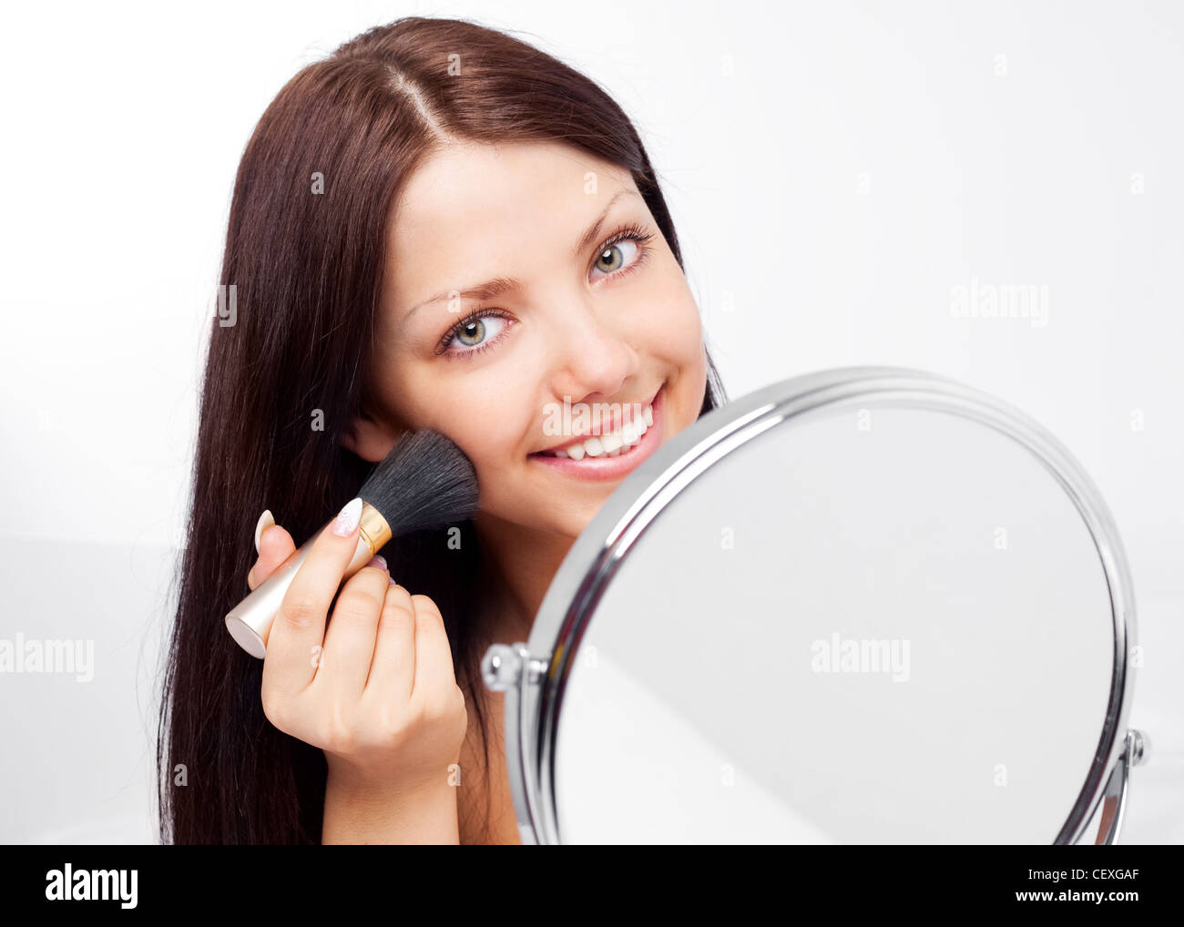 young woman applying powder with a brush Stock Photo - Alamy
