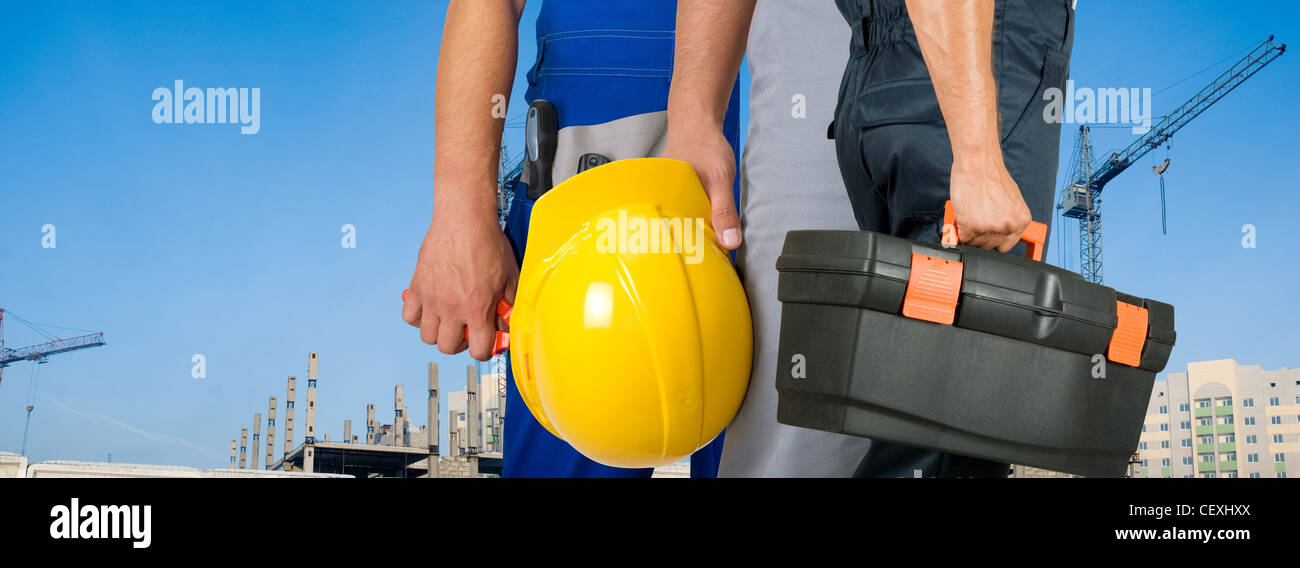 Different workers man closeup on building background Stock Photo - Alamy