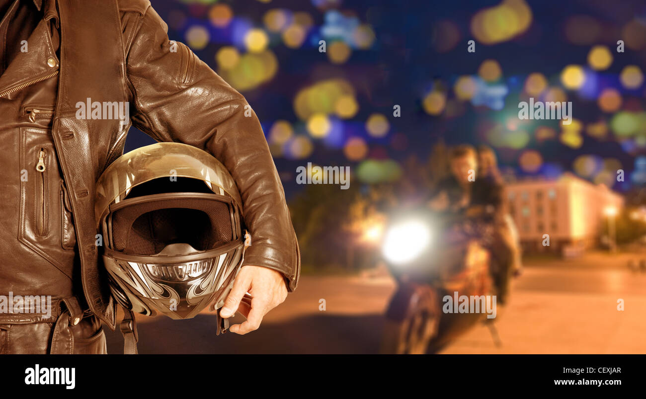 Biker closeup at night city background Stock Photo - Alamy