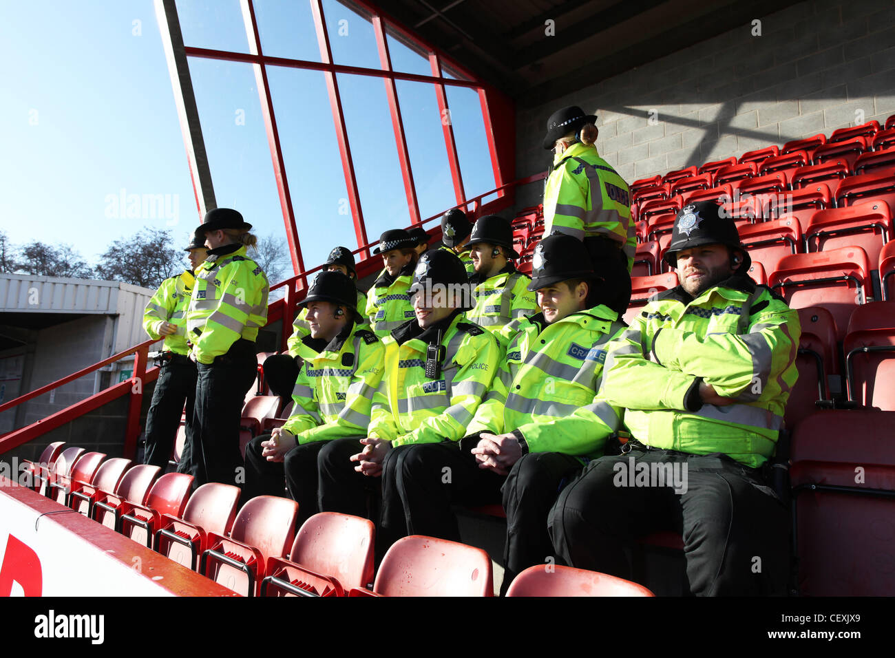 Police officers sitting in a football stadium stand. Picture by James ...