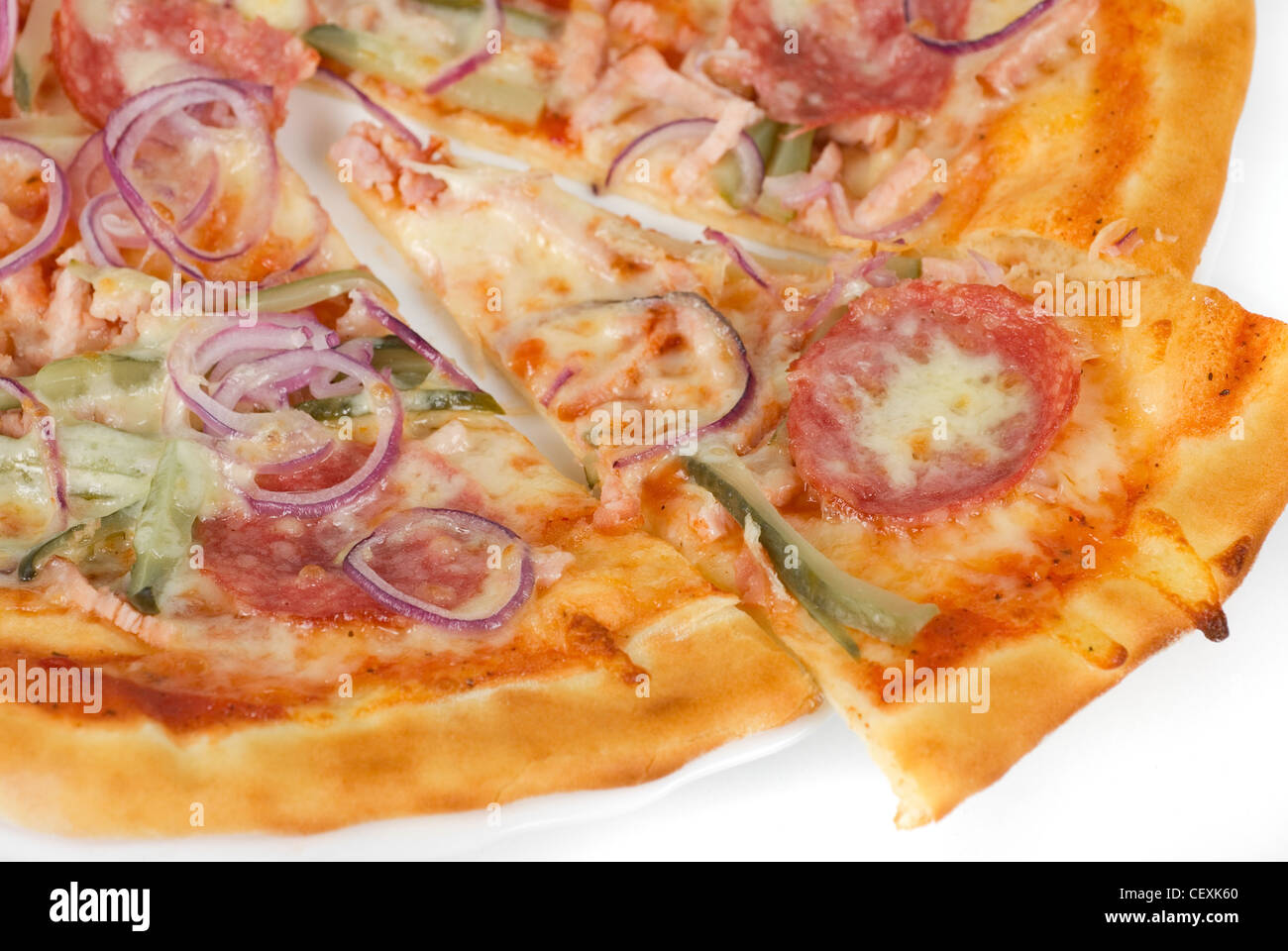 pizza closeup with smoked meat, salami, gherkin, onion and mozzarella ...