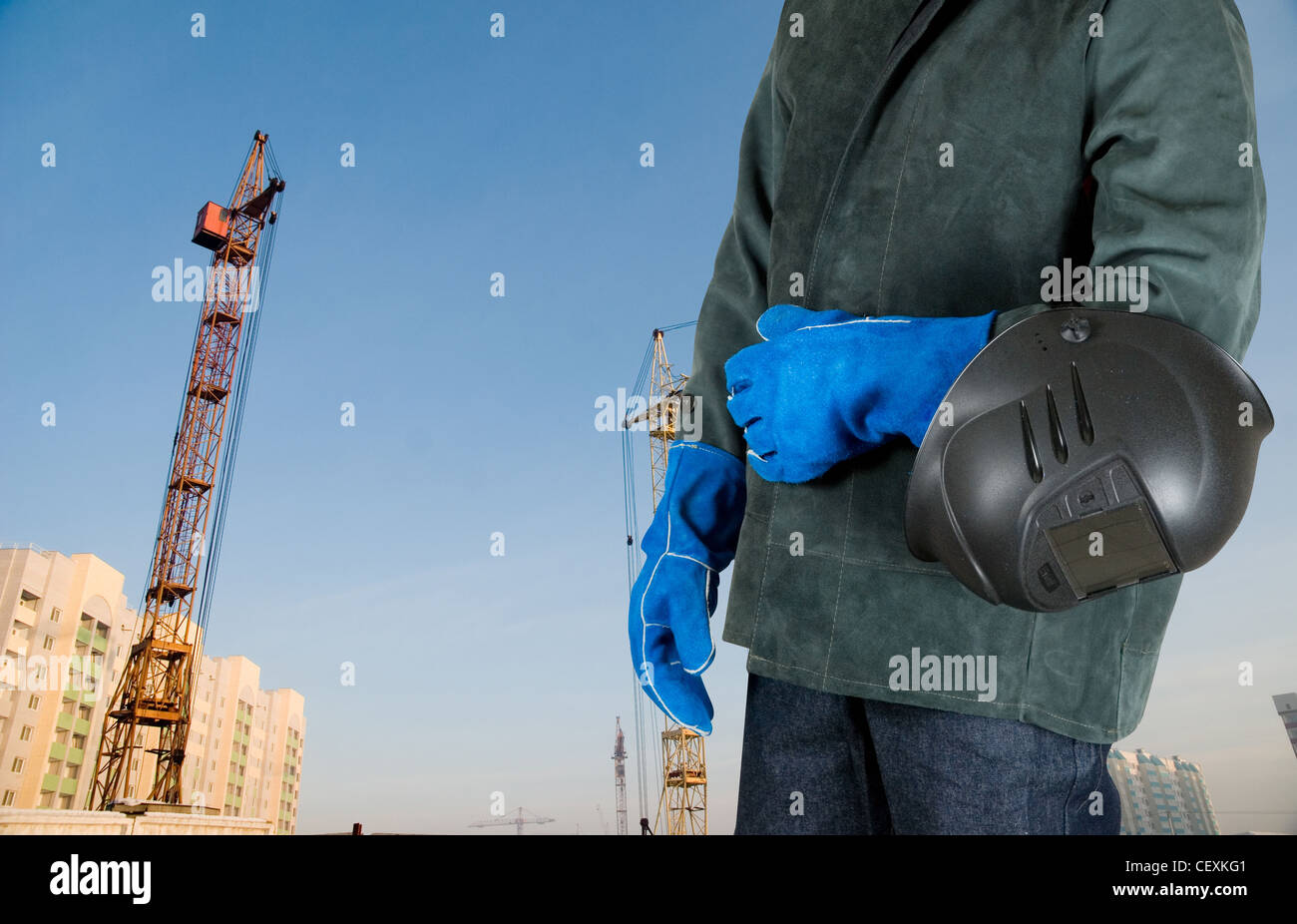 male welder closeup with welding equipment on building background Stock ...