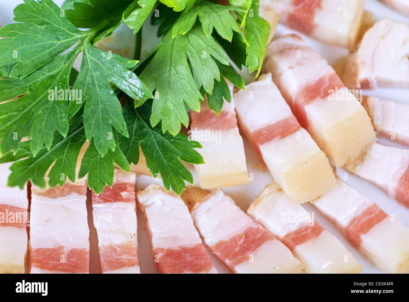 Sliced pig lard with greens closeup Stock Photo - Alamy