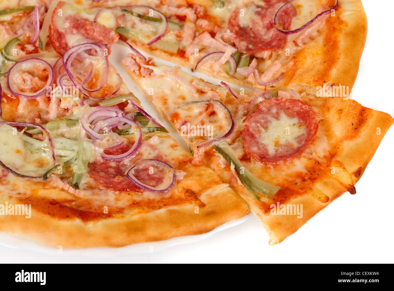 pizza closeup with smoked meat, salami, gherkin, onion and mozzarella ...