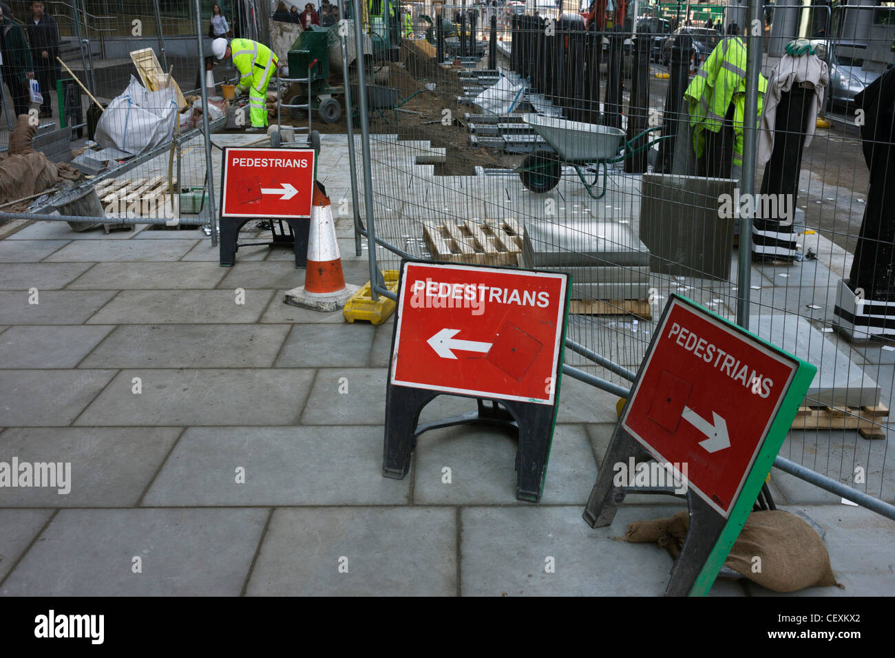 Three pedestrian signs show differing directions for passers-by in ...