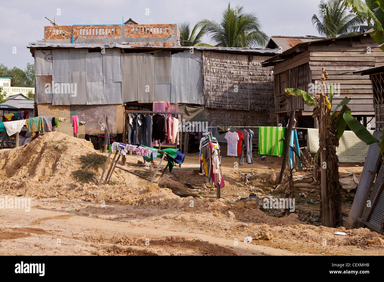 Wooden hand-built houses with washing hanging out, along Siem Reap ...