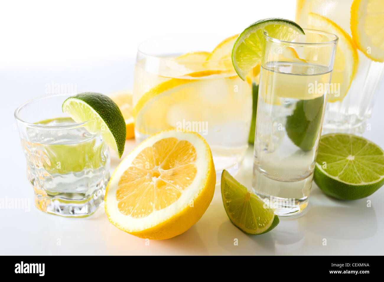 drinks with lemon and lime, shot on reflective white background Stock ...