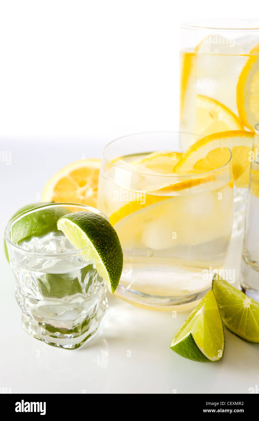 drinks with lemon and lime, shot on reflective white background Stock ...