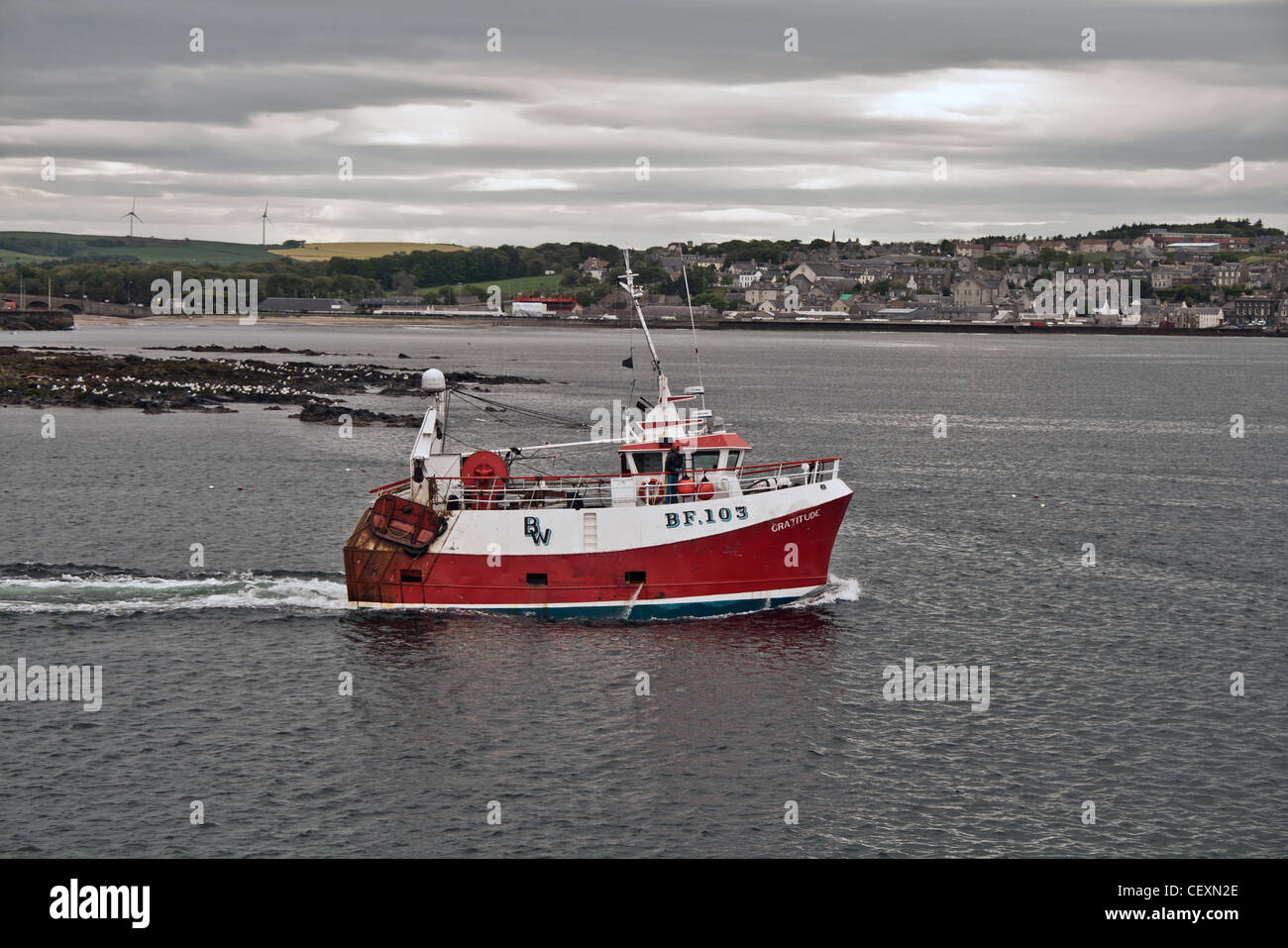 Fishing boat leaving the port of Macduff ne Scotland Stock Photo - Alamy