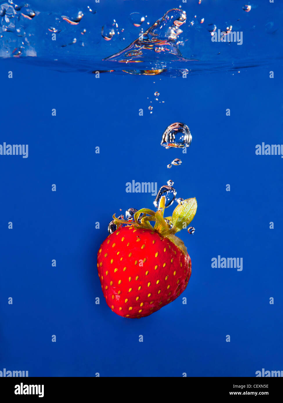 a strawberry splashing in water Stock Photo - Alamy