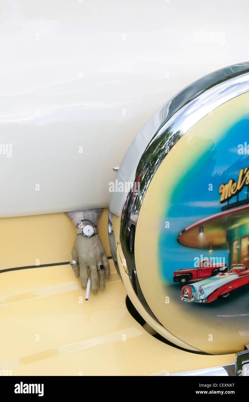 The rear of an American 1950's car with a fake arm popping out from the ...
