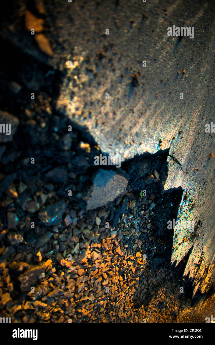 Pavement and road split, and crushed from force. Overhead, vertical ...