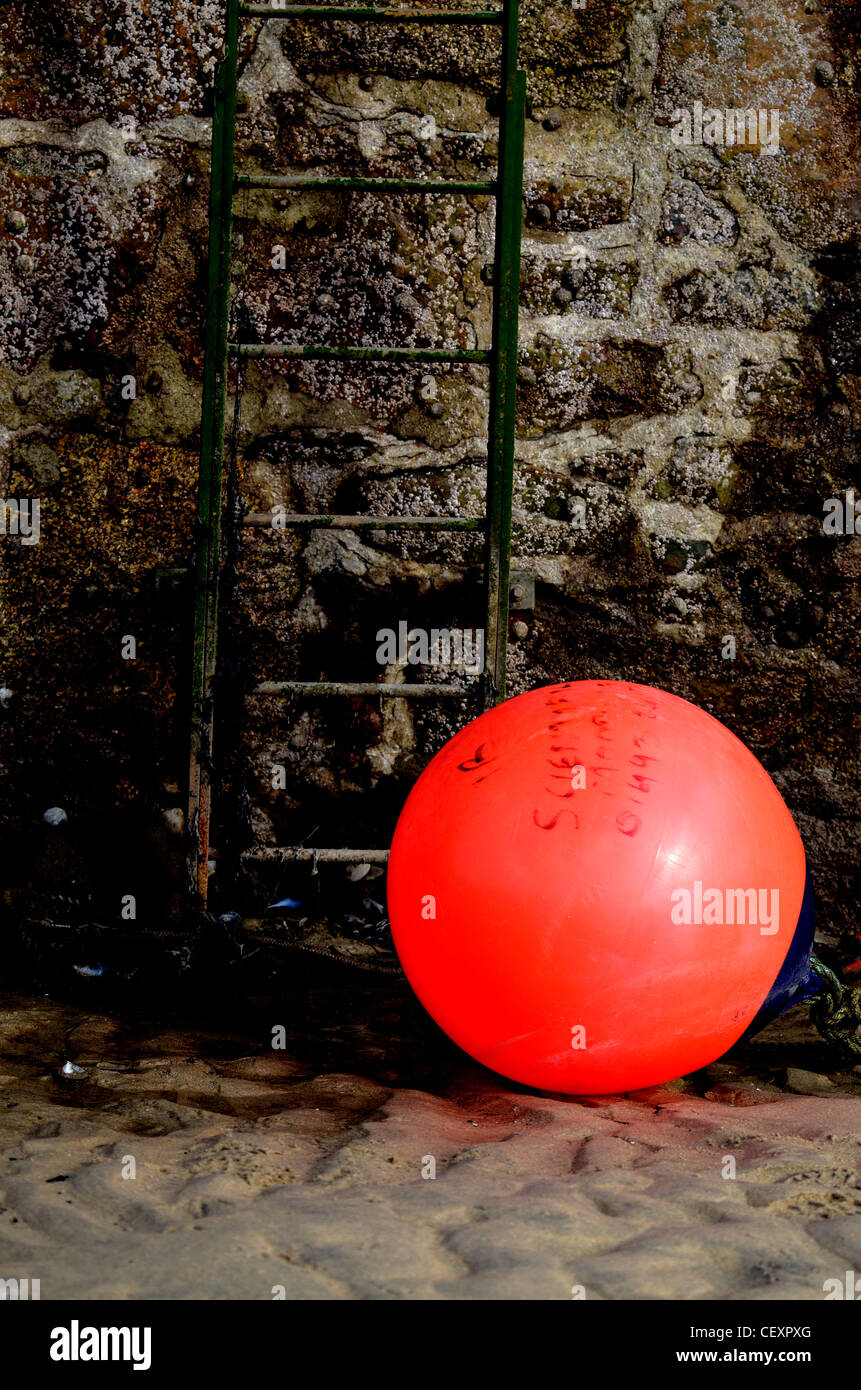 Big orange float or buoy near harbor ladder Stock Photo - Alamy