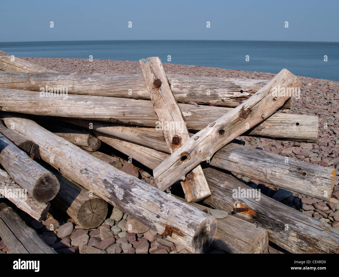Pile of logs on the beach, Porlock Weir, Somerset, UK Stock Photo - Alamy