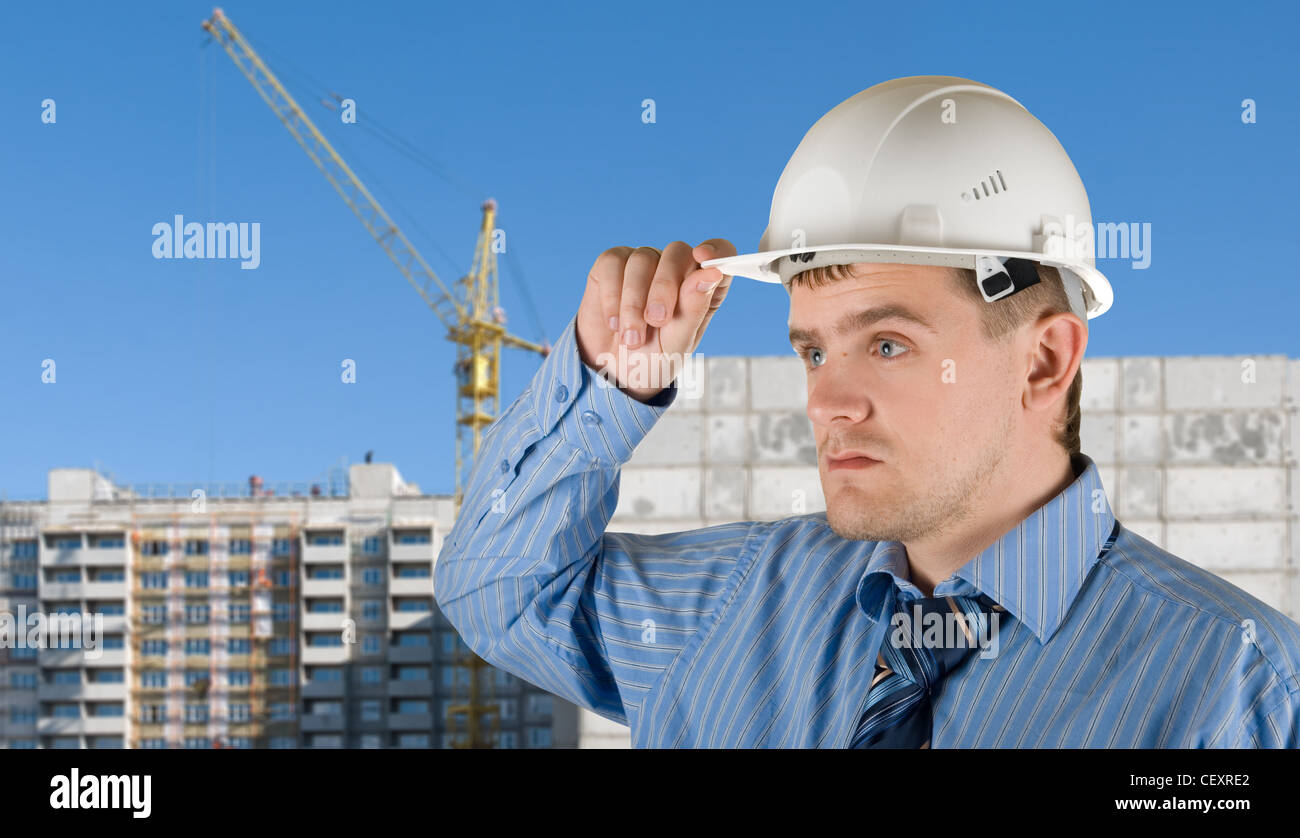 Engineer at white helmet on building background Stock Photo - Alamy