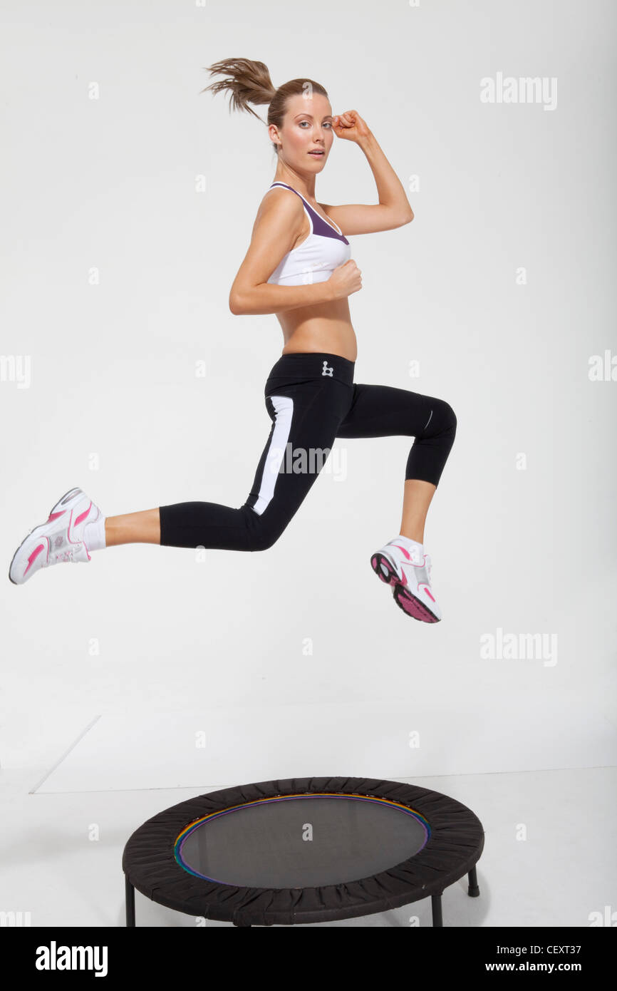 Female fair hair tied into ponytail, wearing a cropped vest, black ...