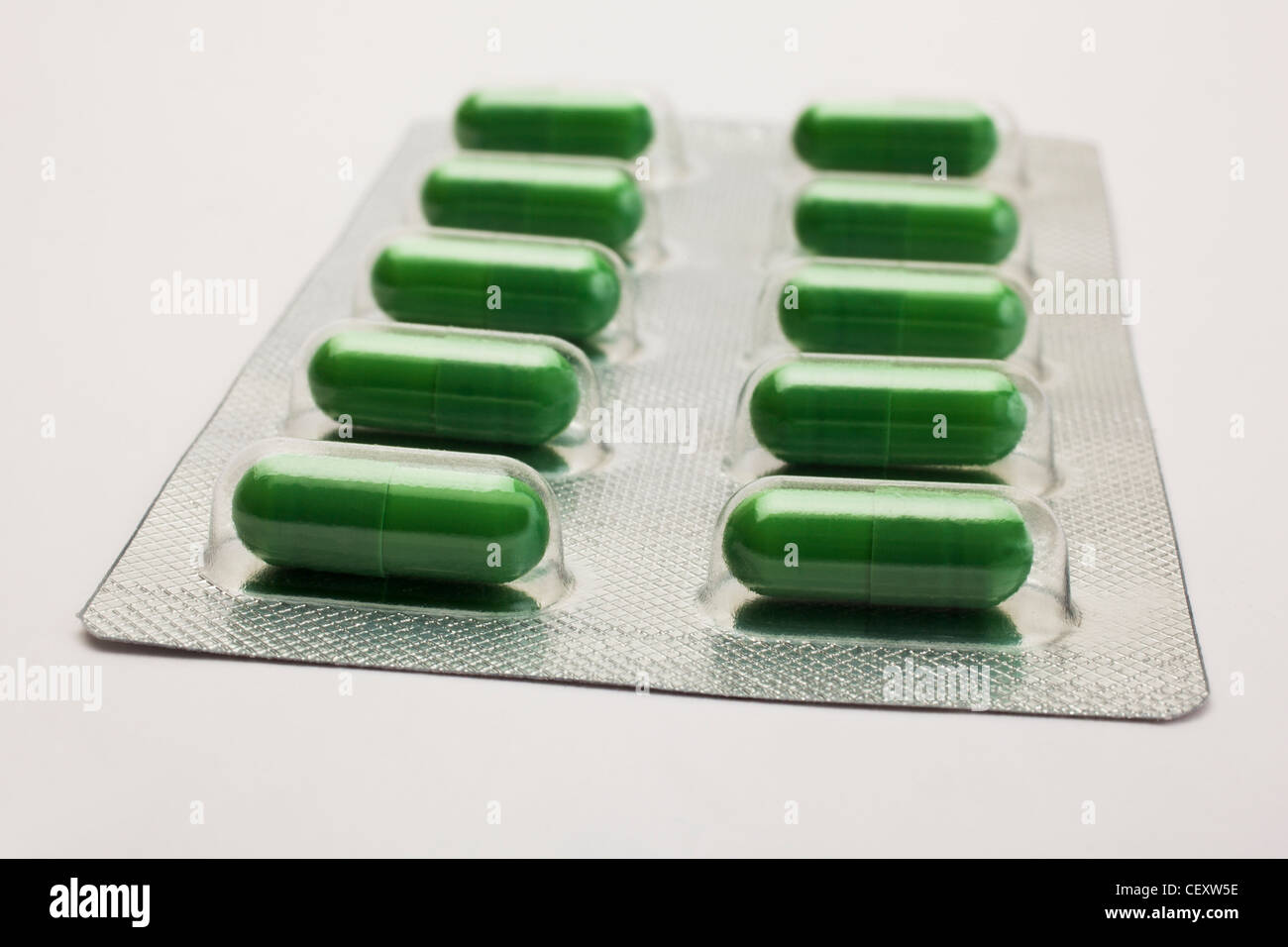 Green medication capsules in blister pack Stock Photo - Alamy