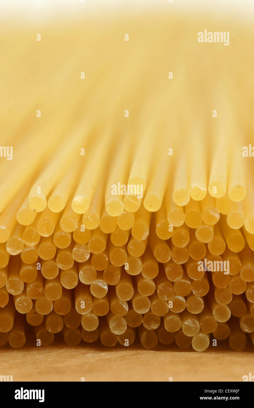 A close up of the ends of spaghetti lying on greaseproof paper Stock ...