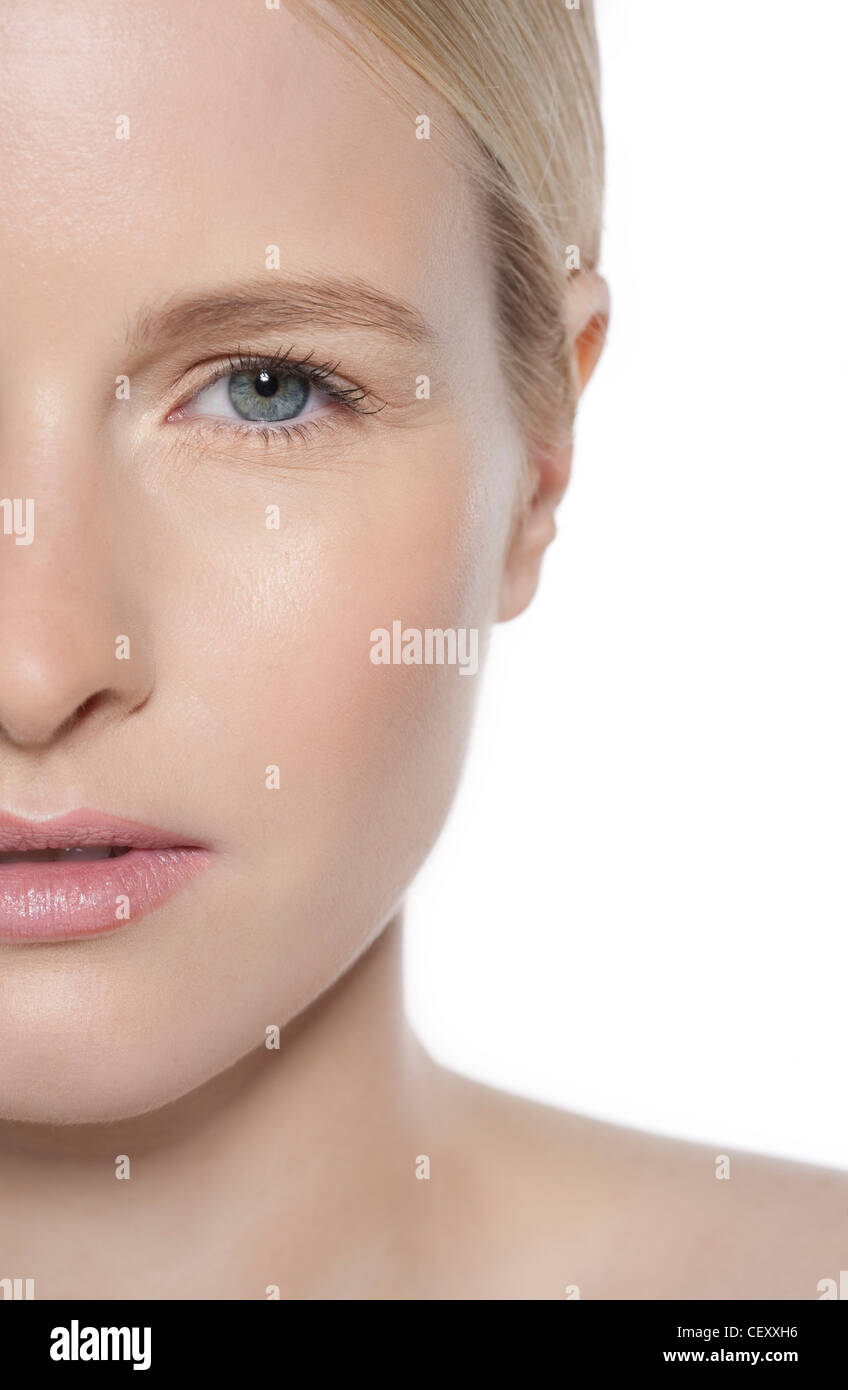 Female with blonde hair off her face, wearing subtle make up, unsmiling ...