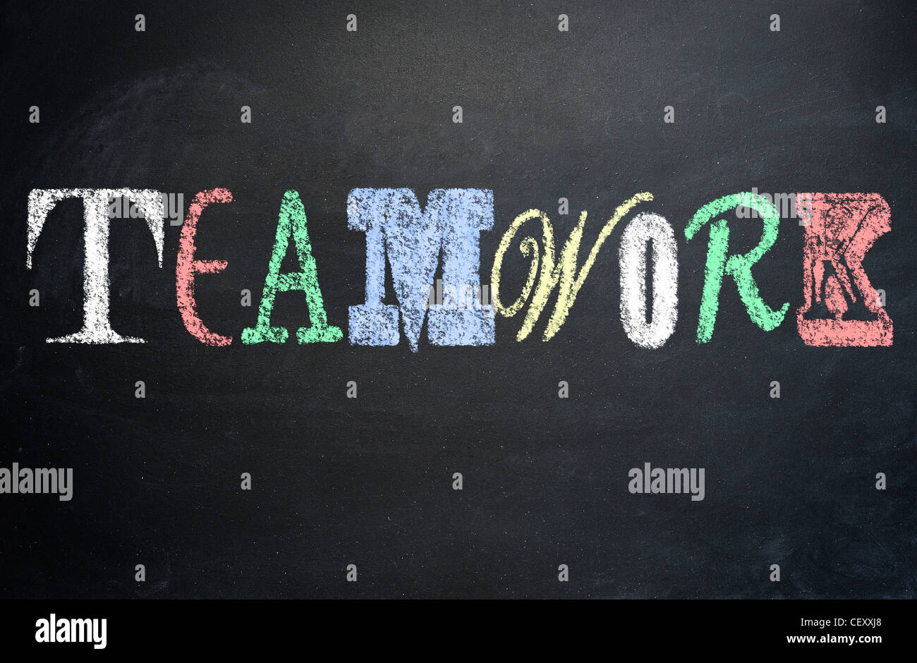 The word 'TEAMWORK' written in different fonts and colours in chalk on ...