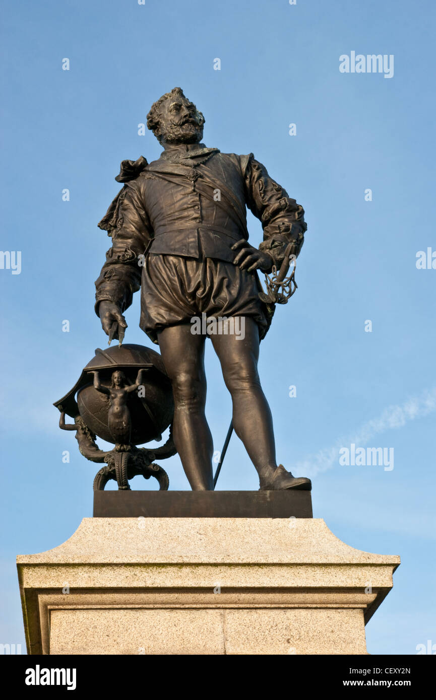 A vertical shot of a bronze statue of Sir Francis Drake, standing on a ...