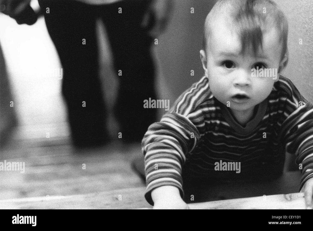Baby boy crawling up stairs Black and White Stock Photos & Images - Alamy