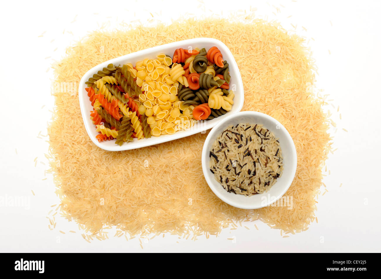 A white bowl filled fusilli tricolore, conchigliette pasta shells, and ...