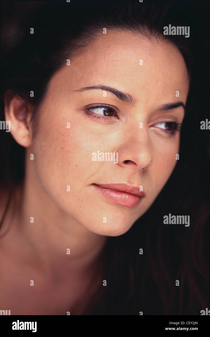 Close up face of female black hair off face wearing subtle make up ...