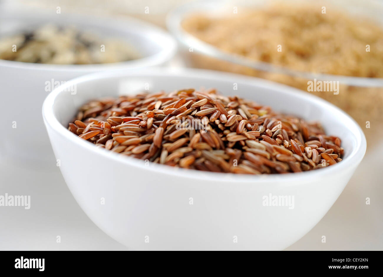 Four bowls of different varieties of rice, with a bowl of red rice in ...
