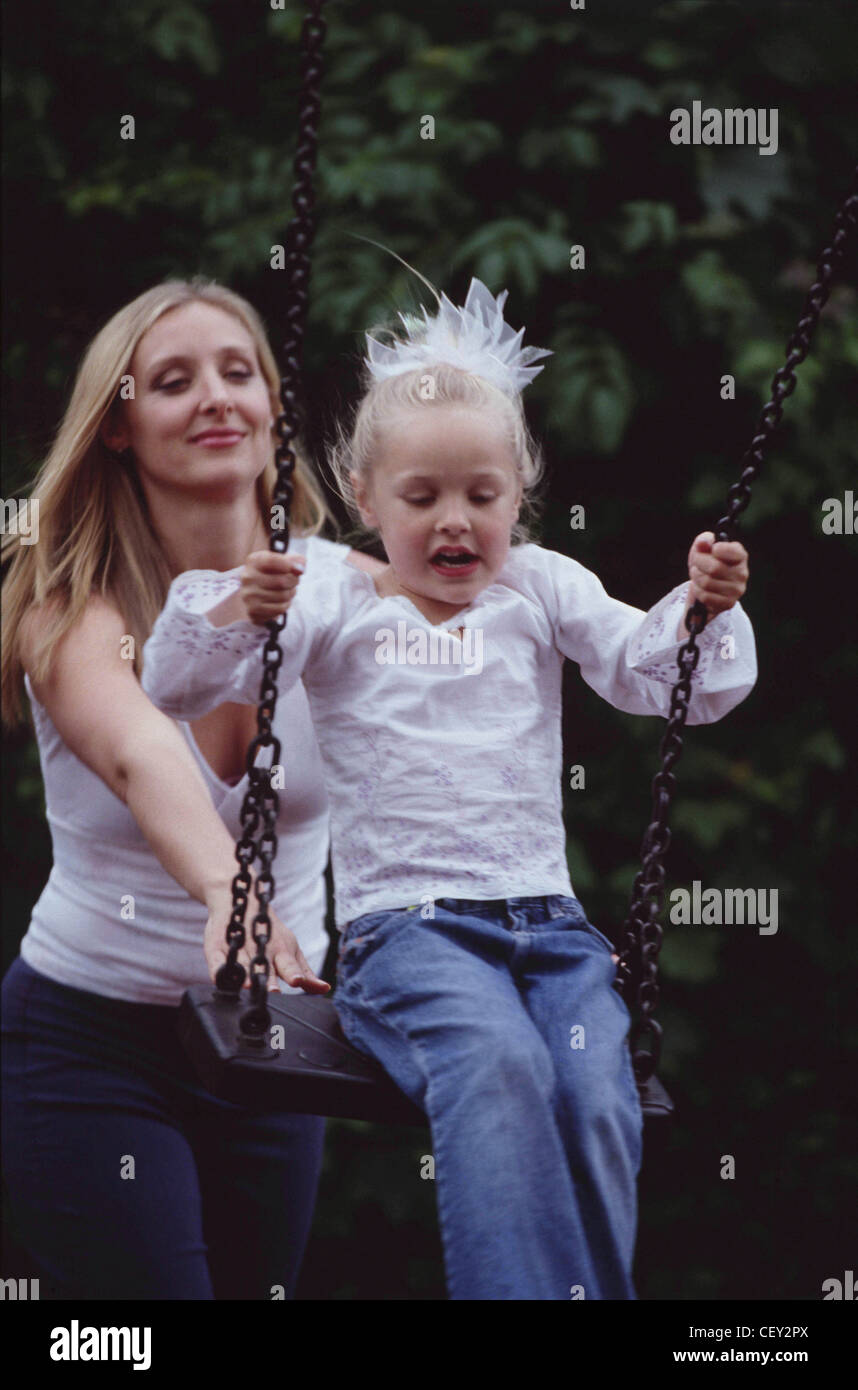 Mother long straight blonde hair pushing female child blonde hair off ...