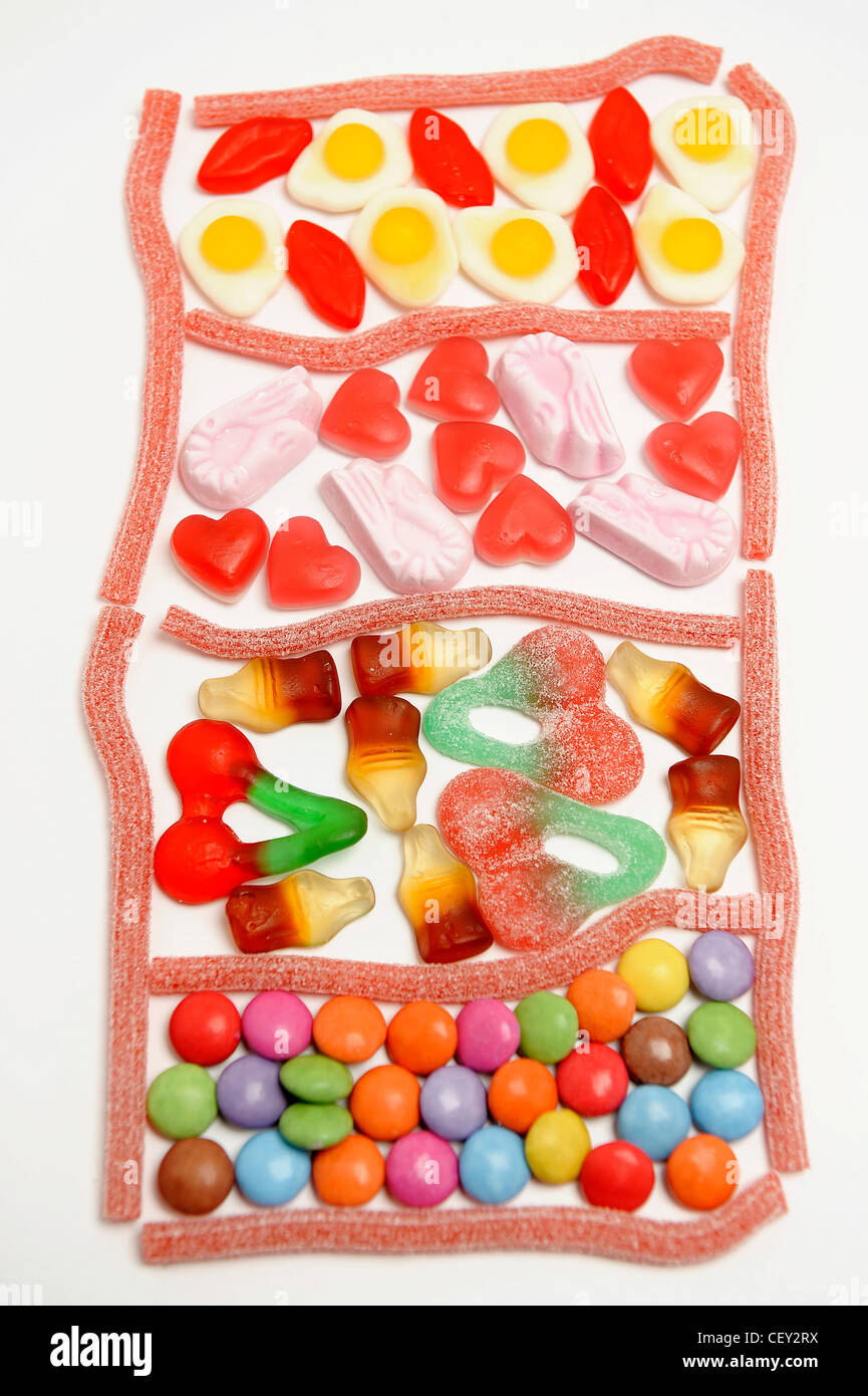 A grid made from strawberry wands filled with different sweets in each ...
