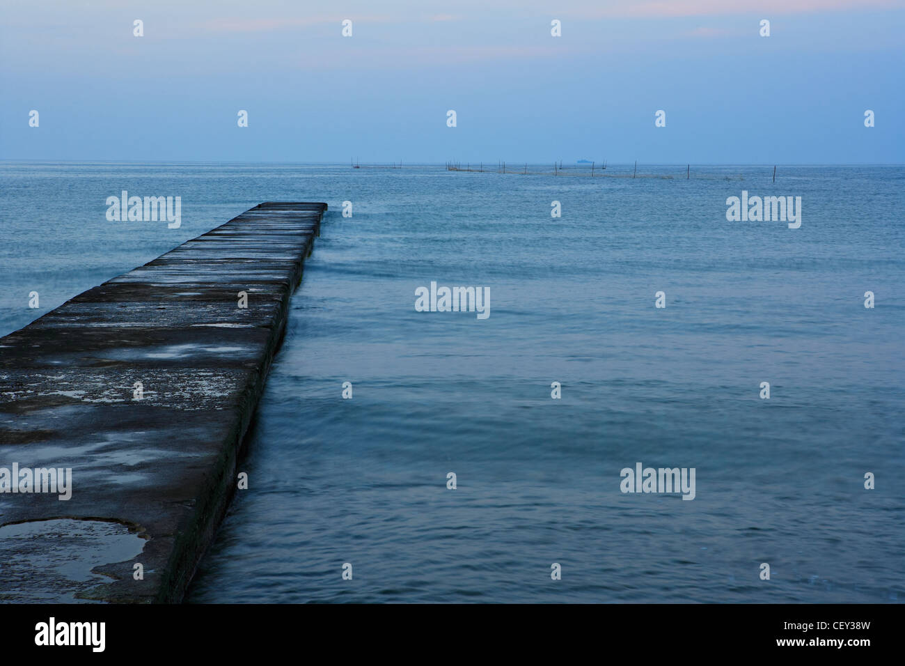 Old quay in a morning blue sea water Stock Photo - Alamy